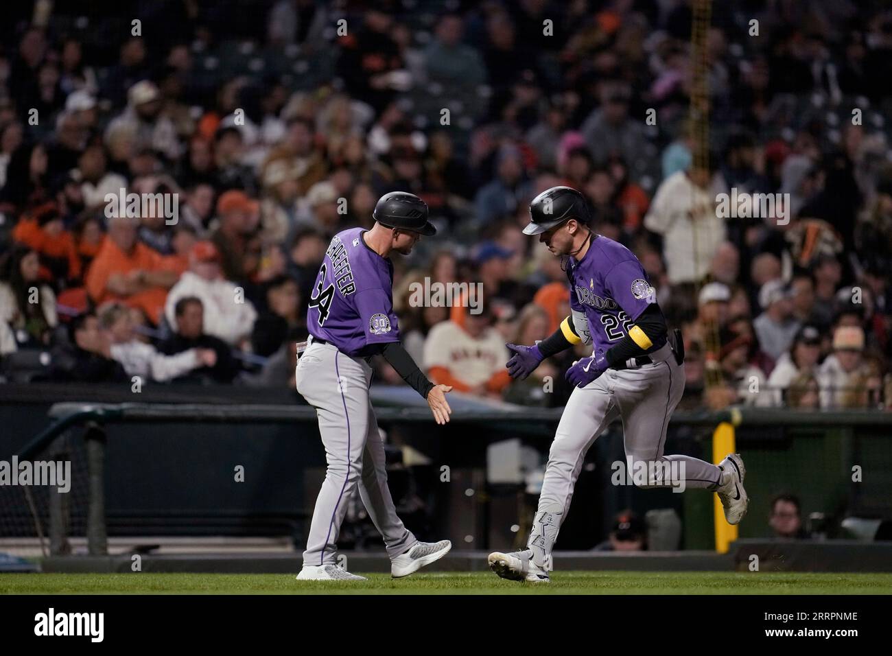 Colorado Rockies' Nolan Jones, right, celebrates with third base coach ...