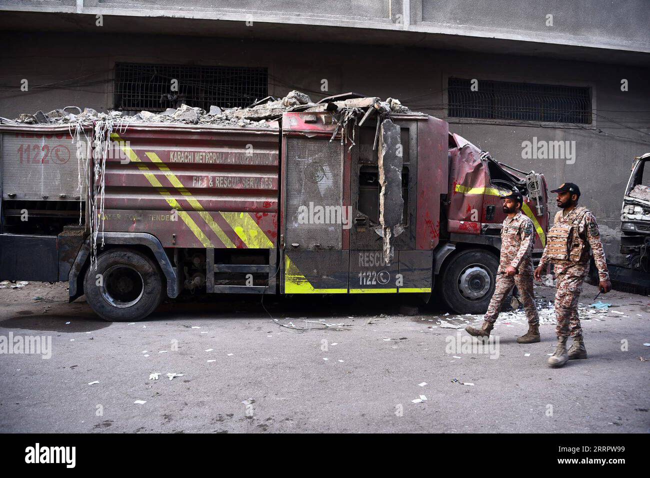 230413 -- KARACHI, April 13, 2023 -- Pakistani security personnel walk ...