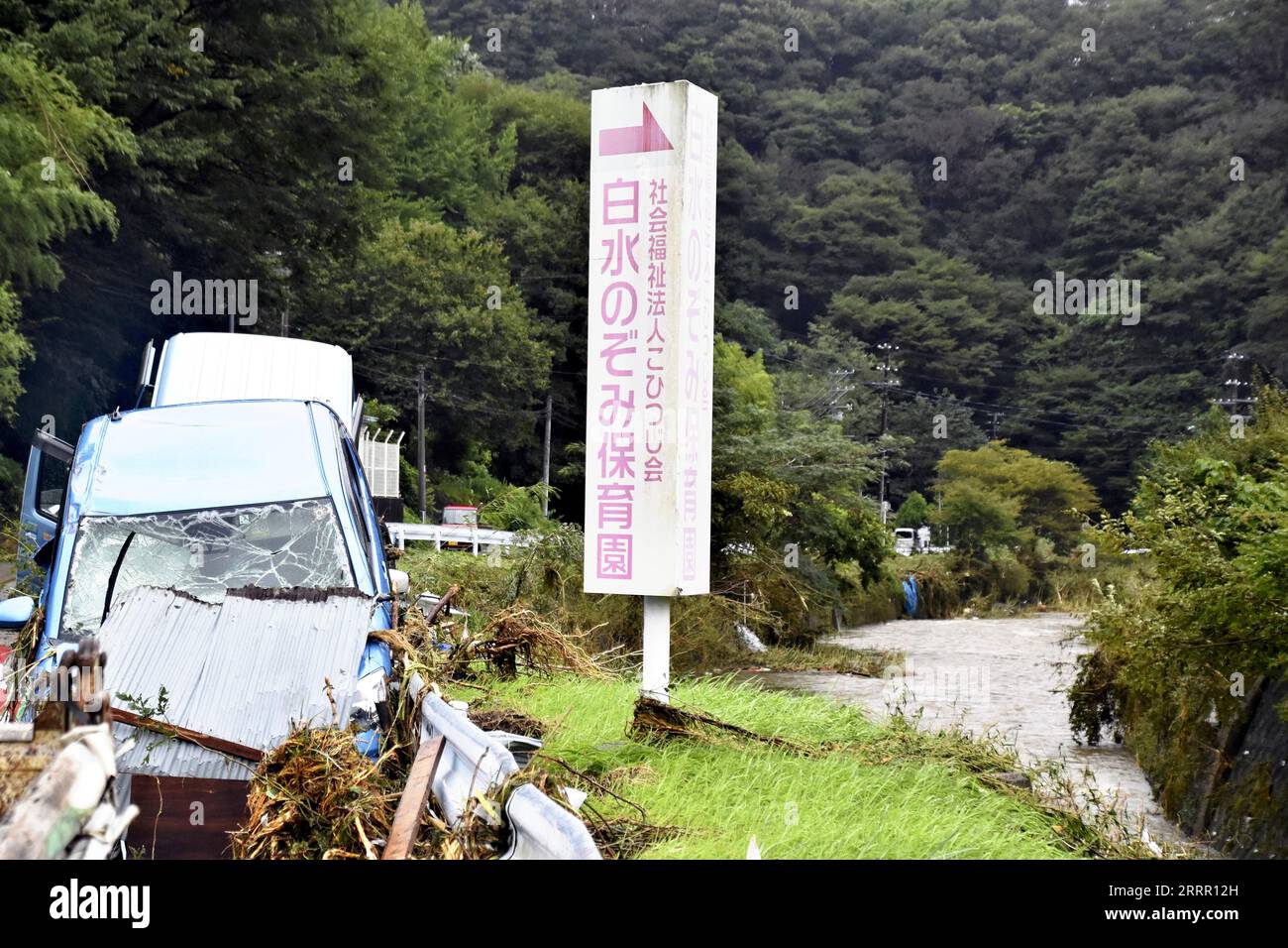 Vehicles believed to have been washed away are left in Iwaki City ...