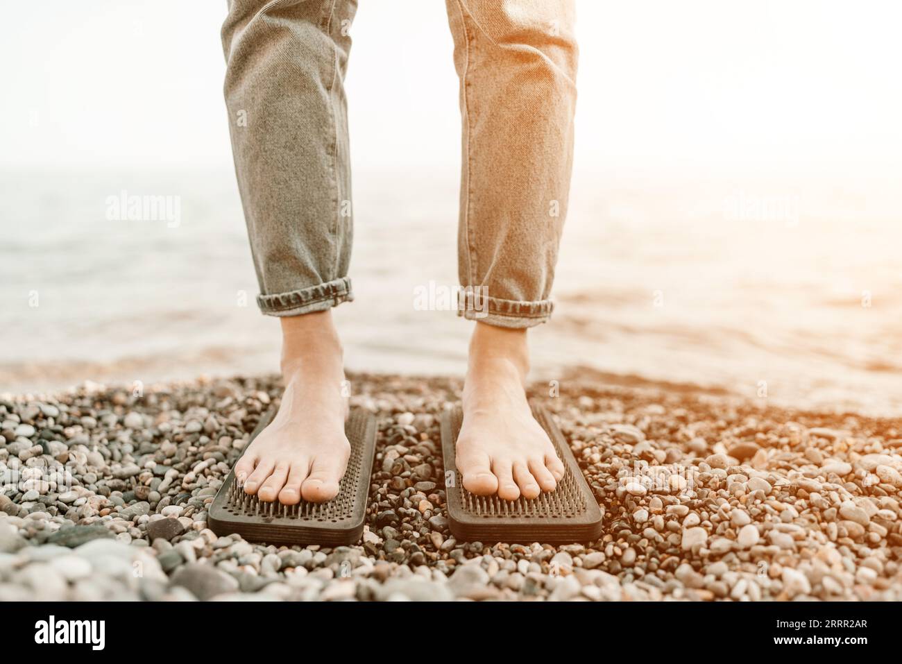 Sea Woman feet stepping on sadhu board during indian practice on the ...