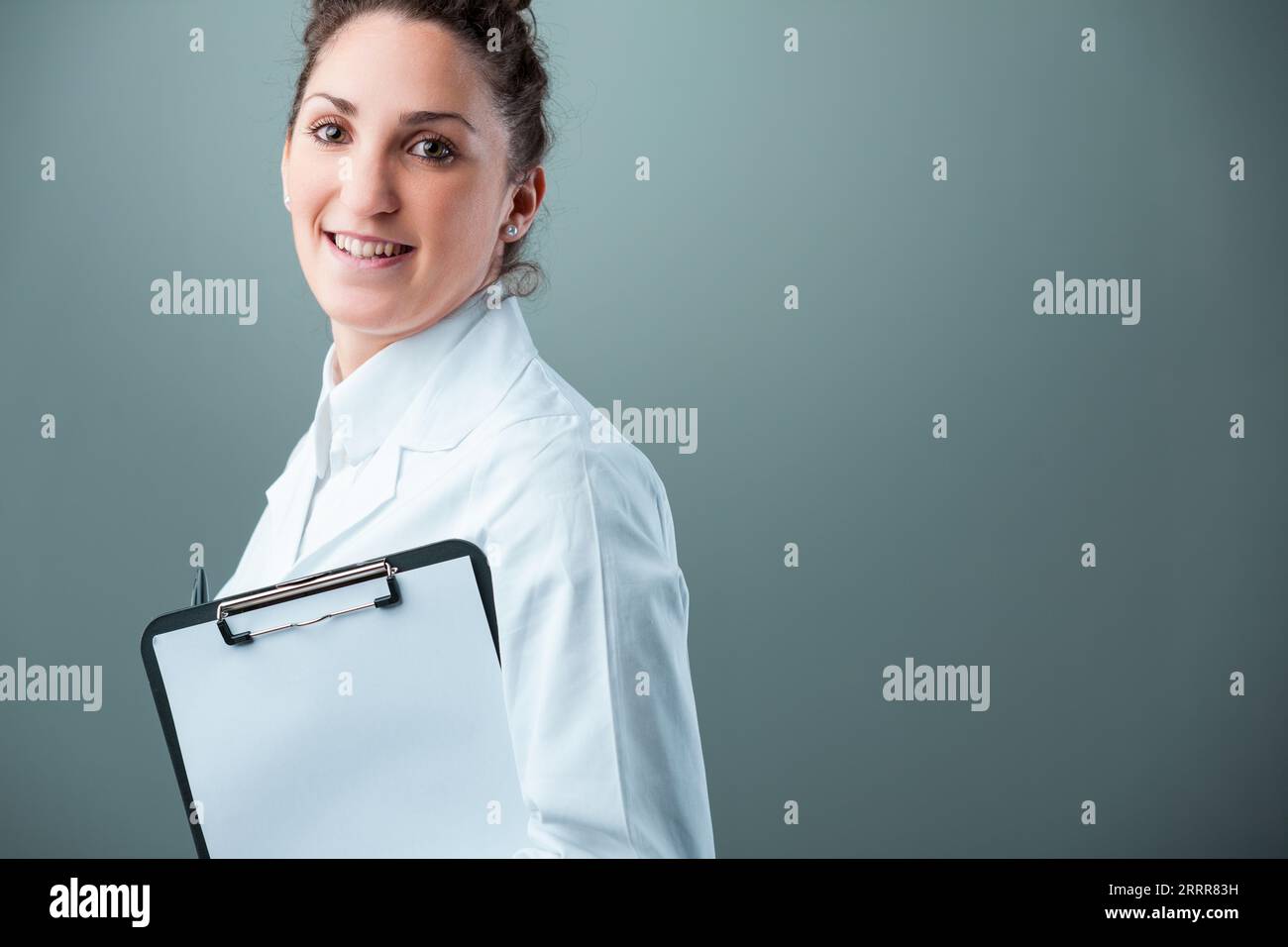 study, a woman, and a reassuring smile. Her tablet symbolizes readiness ...
