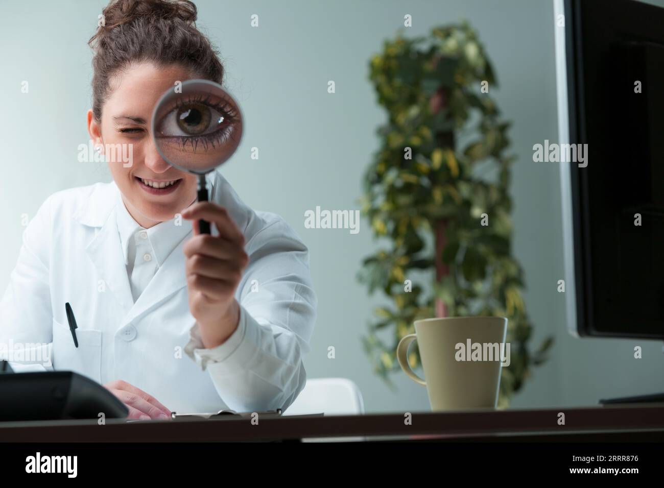 Playful scientist magnifies her eye, displaying a comically enlarged ...