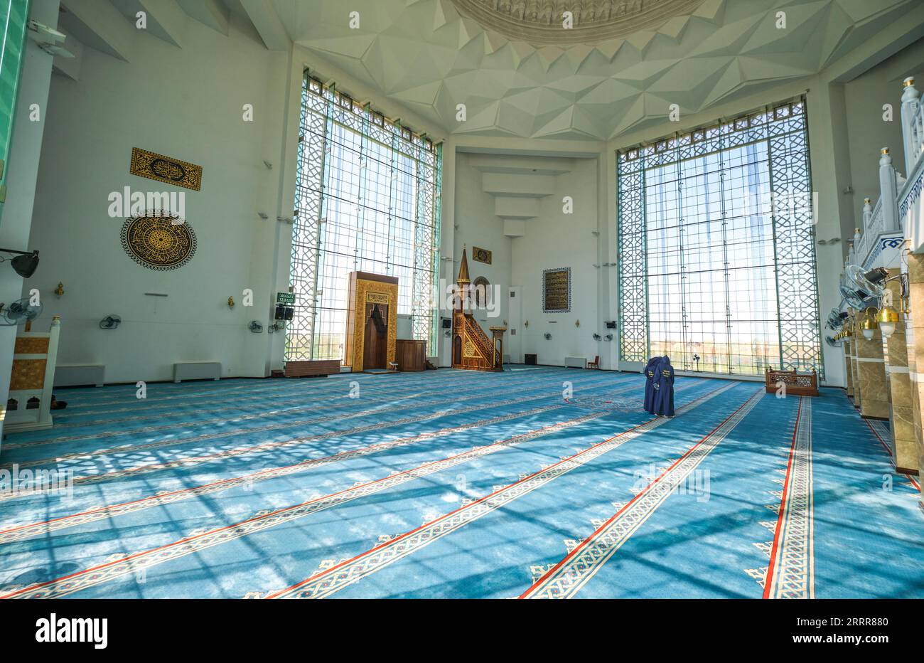 Day interior view of the main prayer hall with large, natural light ...