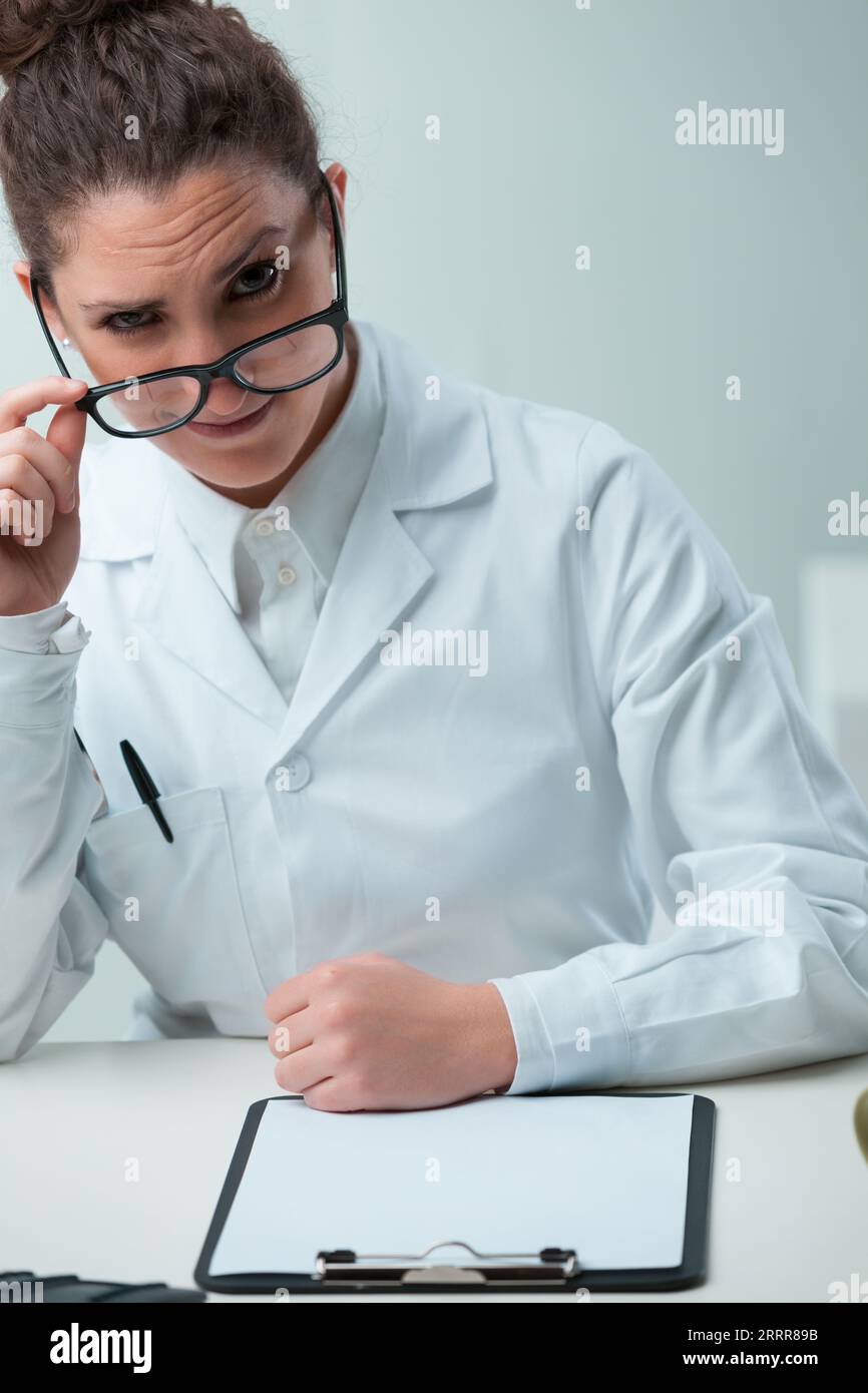 skeptical scientist with black glasses expresses frustration. Upset by ...