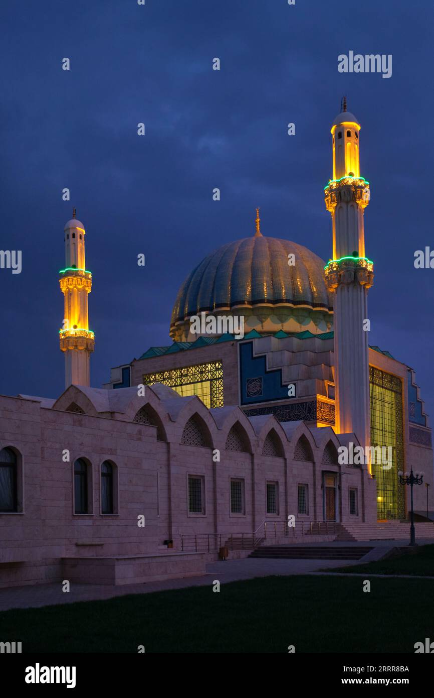 Sunset exterior view of the glowing Khoja Ahmad Yassavi mosque. In ...