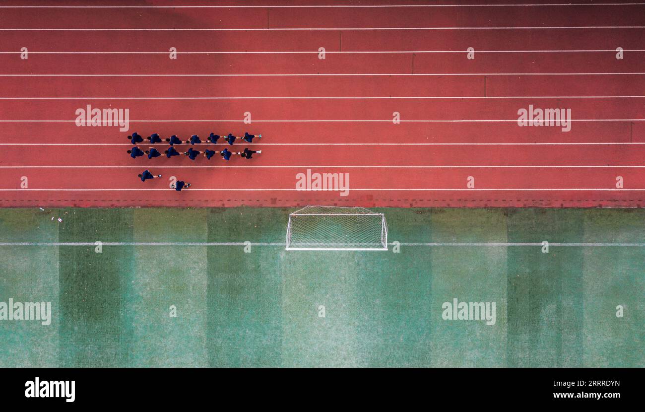 An aerial view of a running track with a group of runners Stock Photo ...