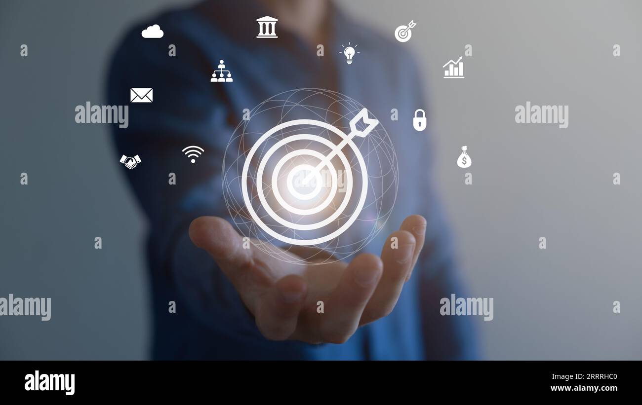 Businessman hand and arrow icon hitting center of dartboard target ...