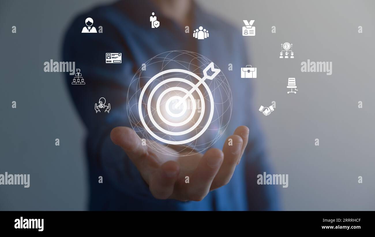 Businessman hand and arrow icon hitting center of dartboard target ...