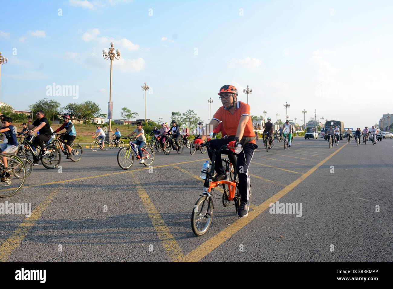 230604 -- ISLAMABAD, June 4, 2023 -- People ride bicycles during an ...