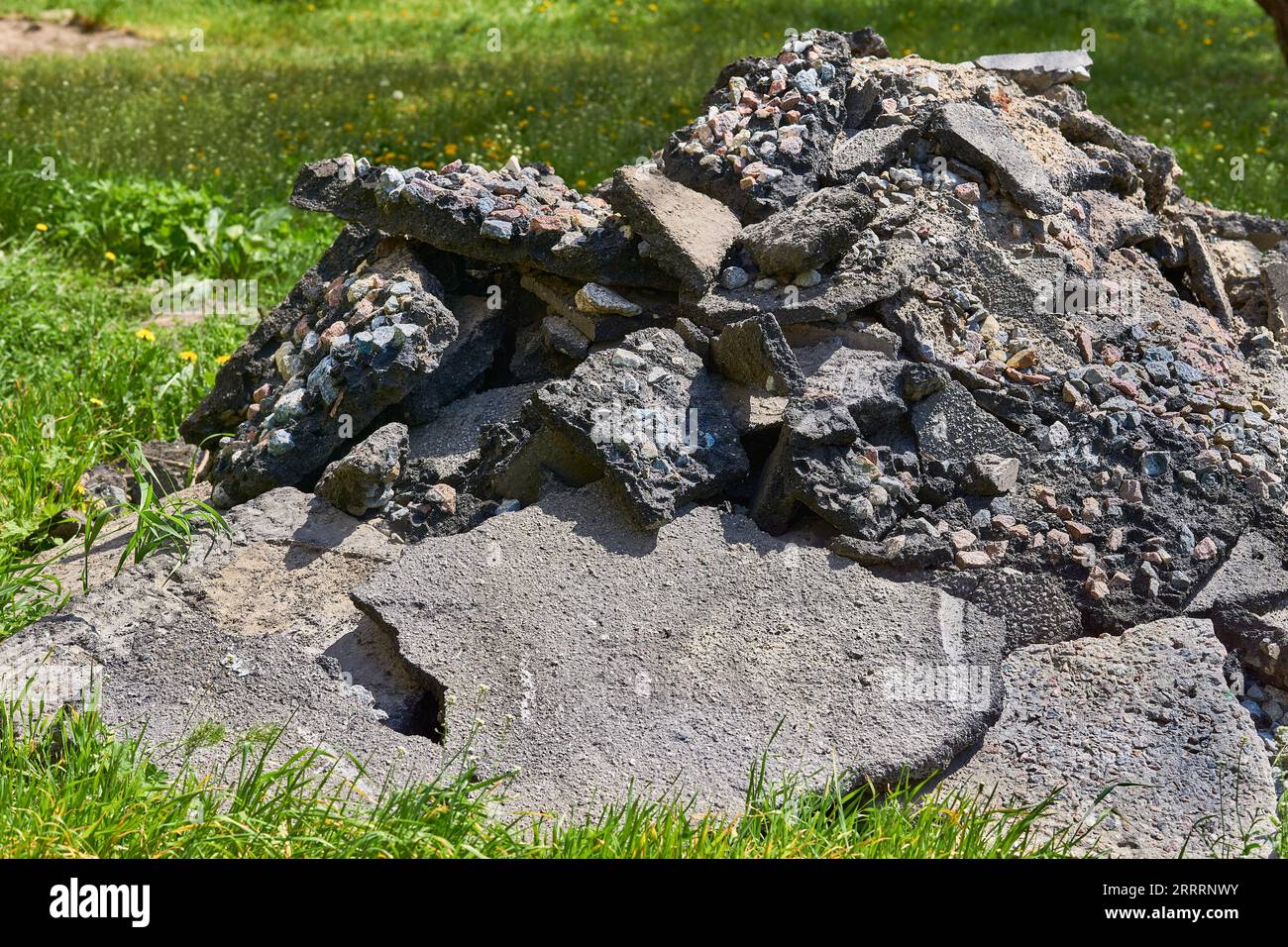 A pile of old broken asphalt with rubble left after the repair of the ...