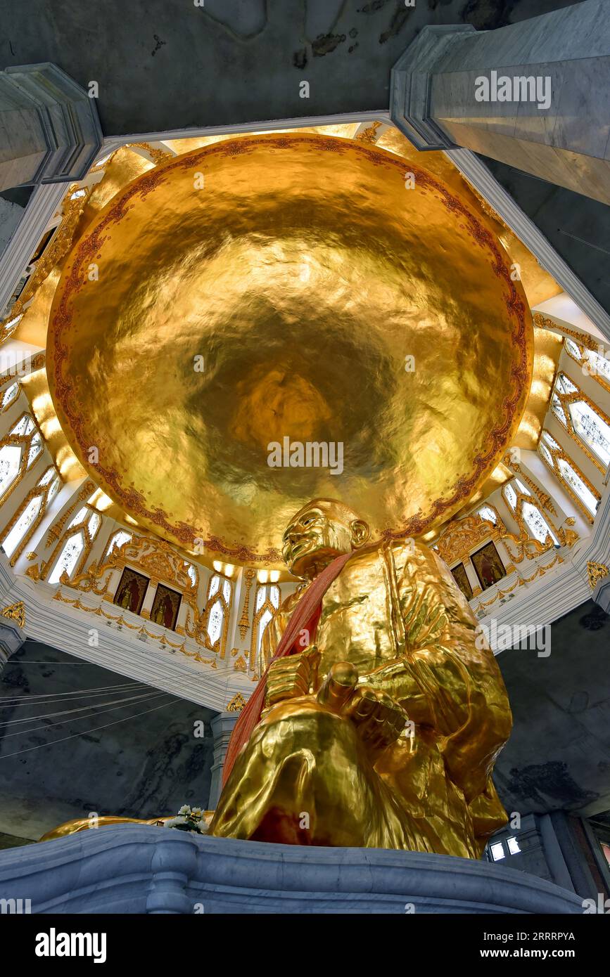 Famous monk statue cover by gold and have a name "Somdet Phra ...