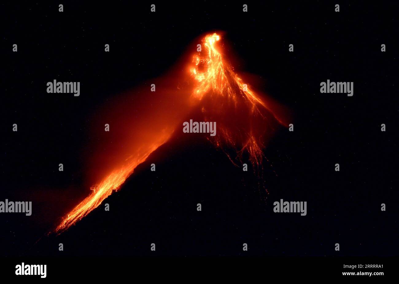 230611 -- ALBAY, June 11, 2023 -- Glowing lava flows from the crater of ...