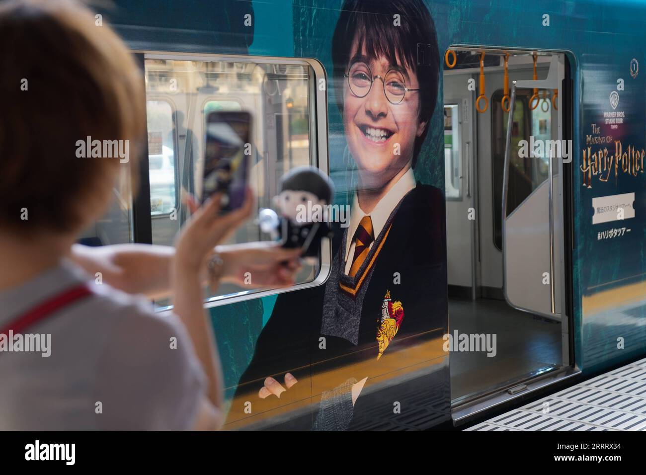 230616 -- TOKYO, June 16, 2023 -- A visitor takes photos of a Harry ...