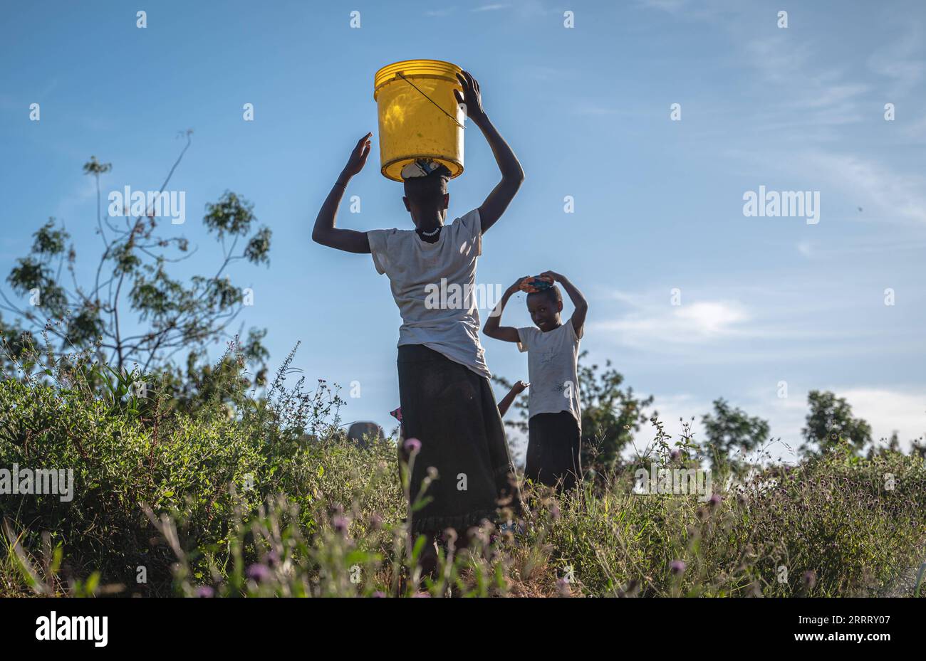 230617 -- MWANZA, June 17, 2023 -- Villagers fetch water from a stream ...