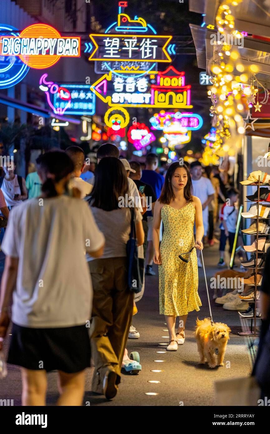 230618 -- CHENGDU, June 18, 2023 -- People walk in a street in Chengdu ...