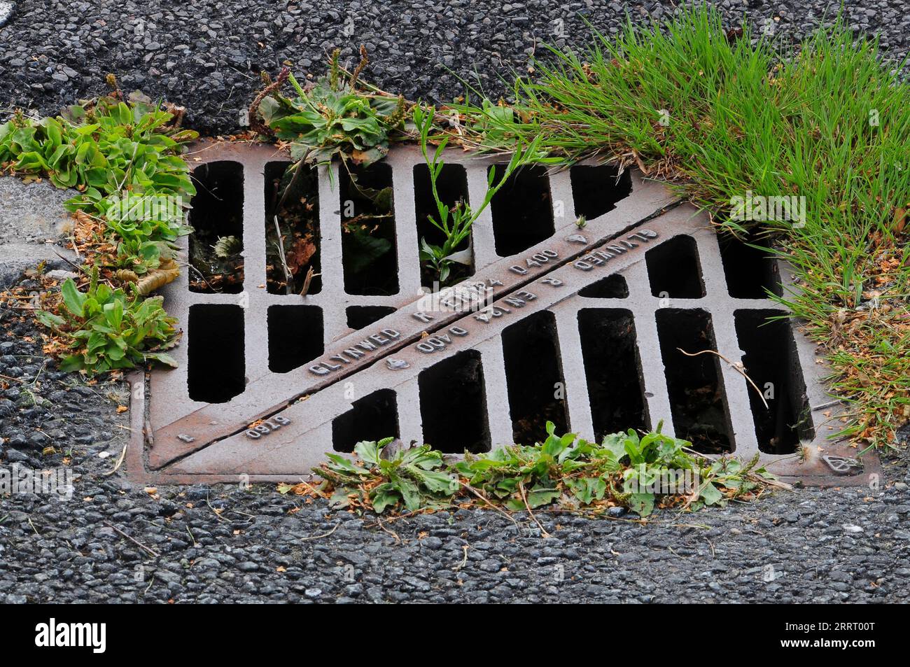 cast iron grating to road rainwater drain Stock Photo - Alamy