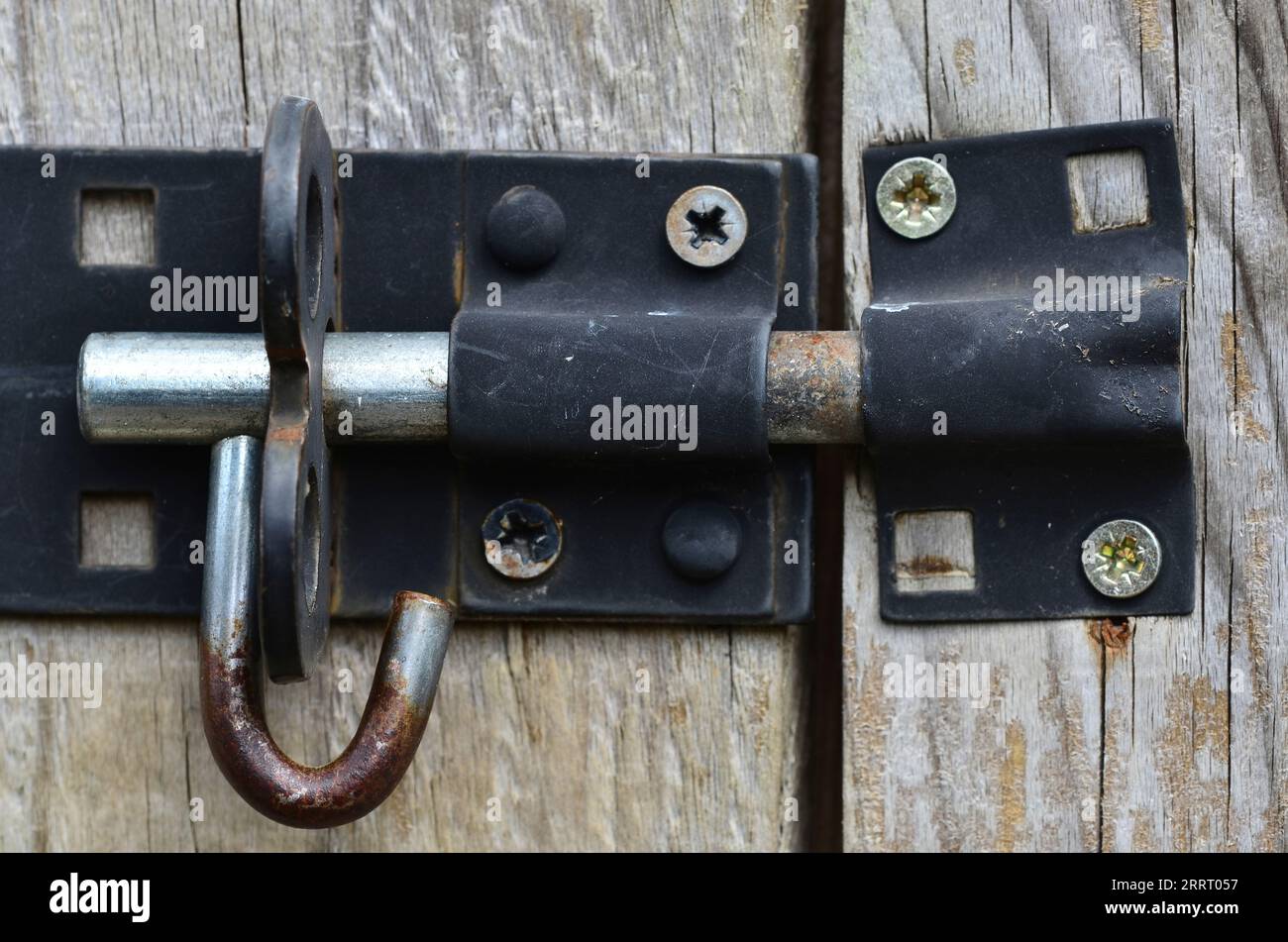 Sliding steel bolt on wooden shed door Stock Photo - Alamy