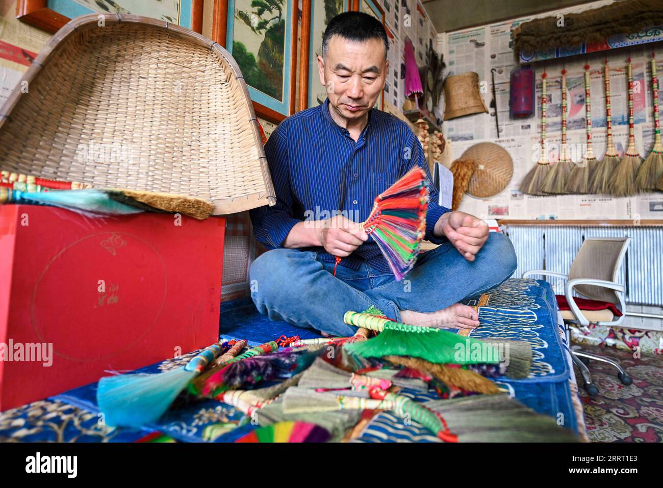 230622 -- CHANGCHUN, June 22, 2023 -- Rong Fengming checks a broom ...