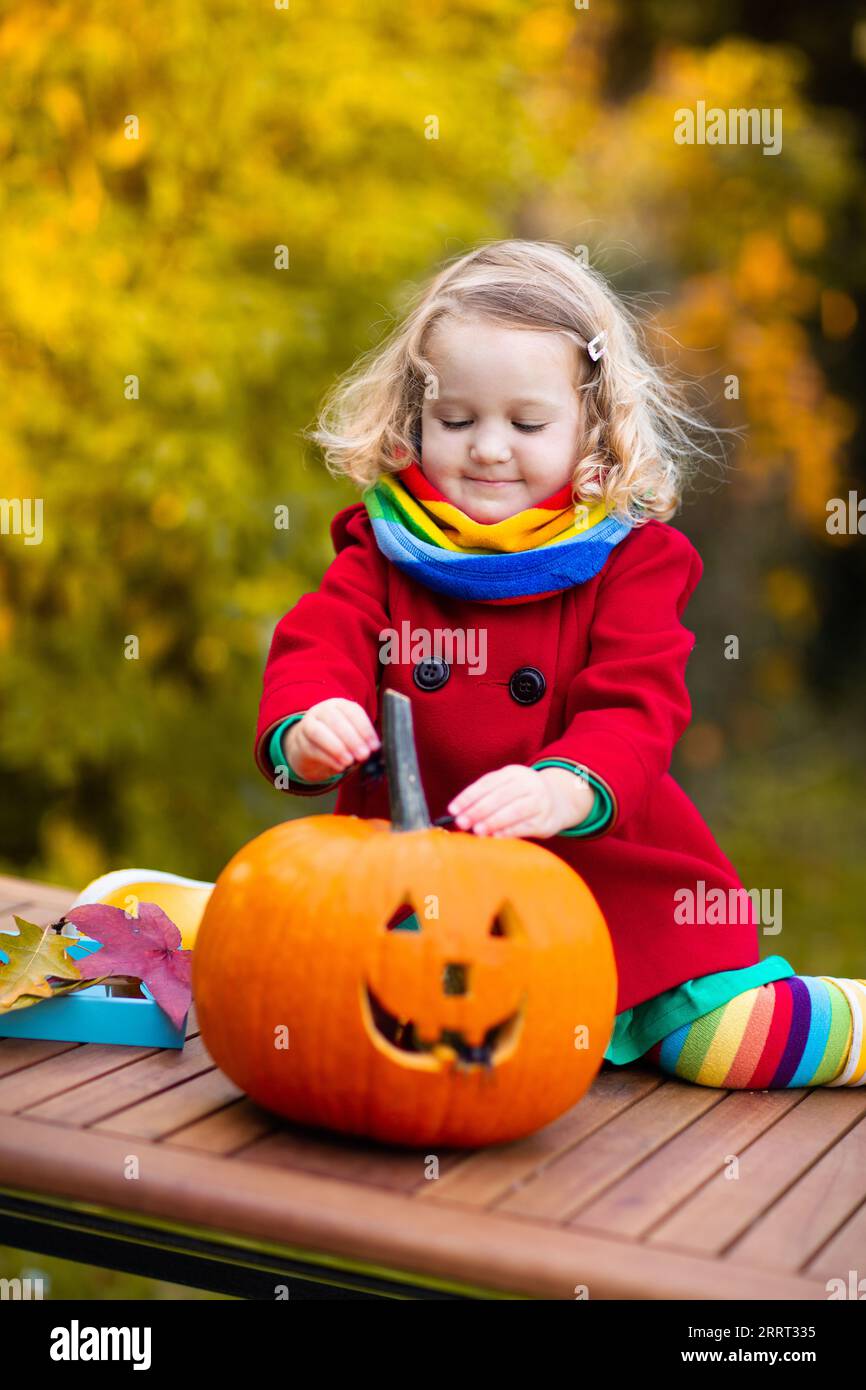 Child carving Halloween pumpkin. Kids carve pumpkins for trick or treat ...