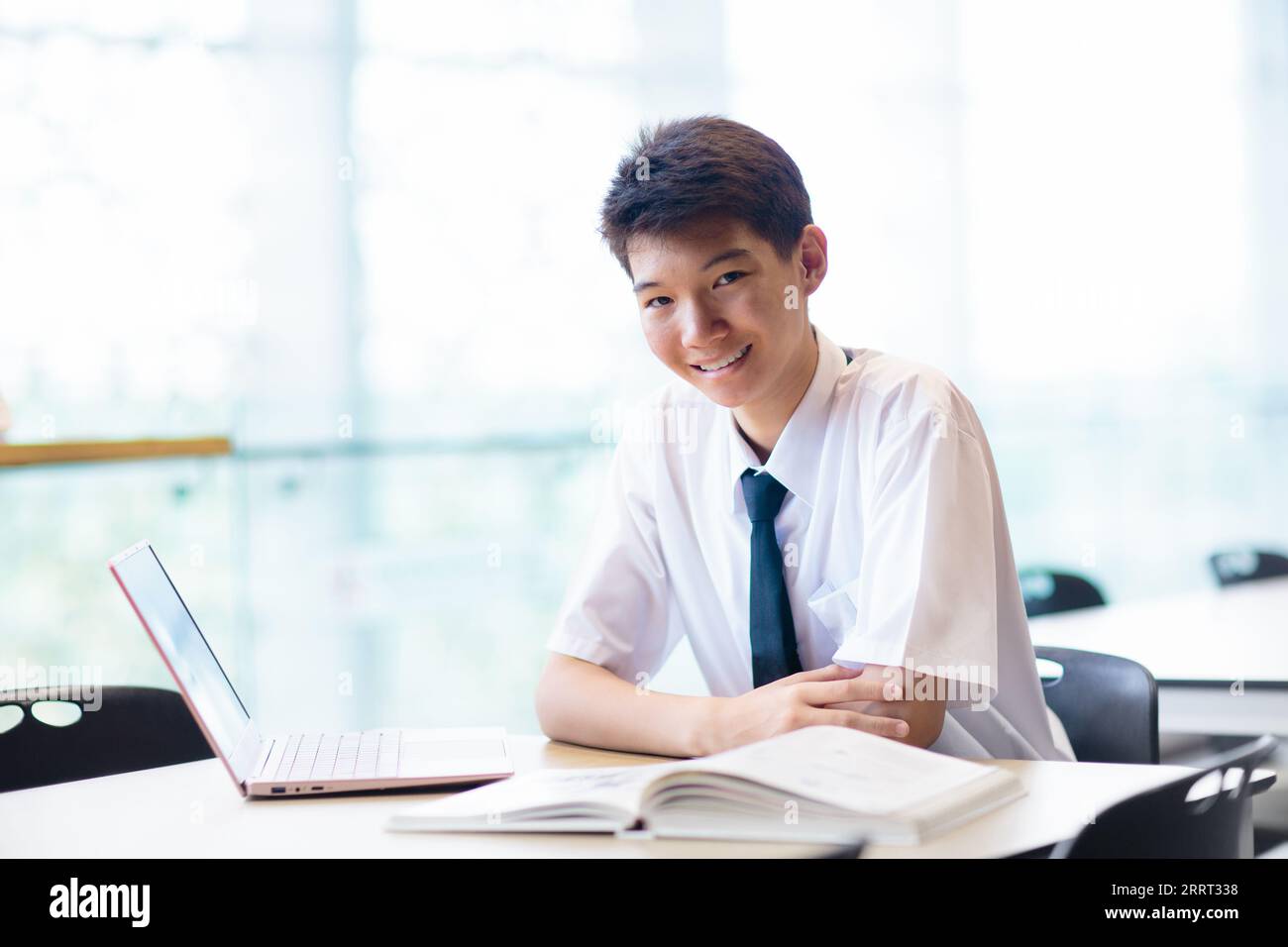 Asian boy with laptop in school. Student in classroom. Teenager in ...