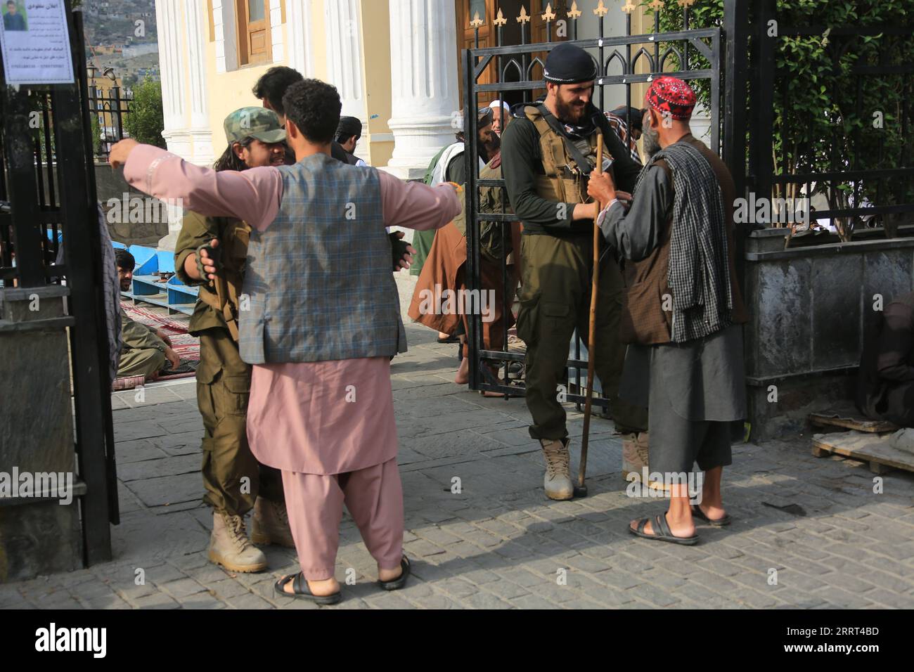 230628 -- KABUL, June 28, 2023 -- Security officials frisk people in ...