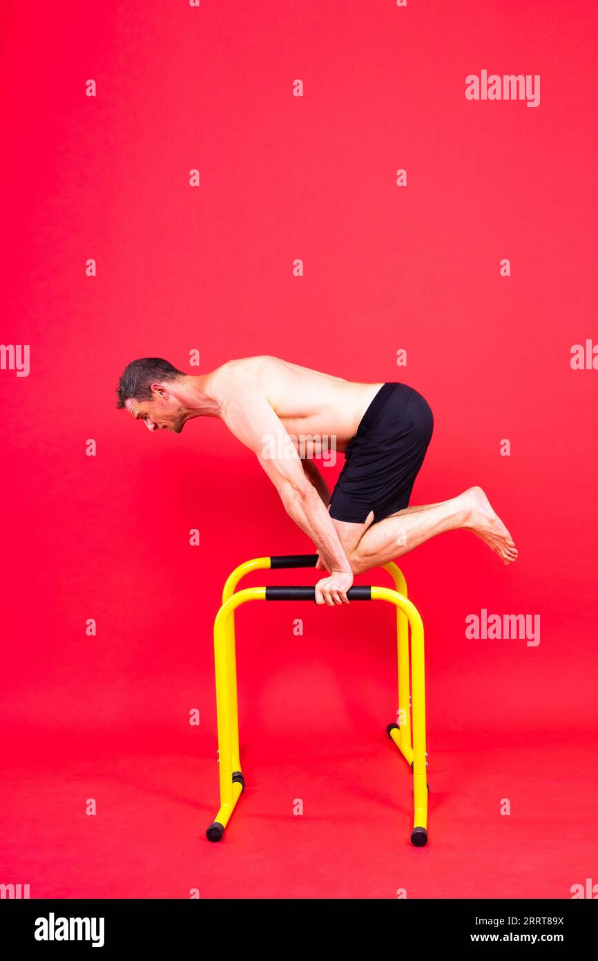 Strong man doing sports. Fitness on gorizontal and parallel bars. Pull ...