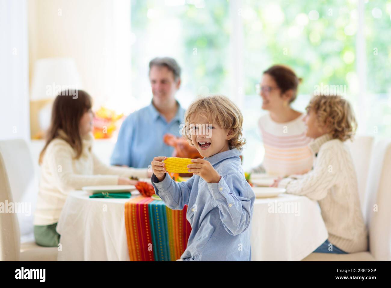 Family at Thanksgiving dinner. Parents and kids enjoy roasted turkey ...
