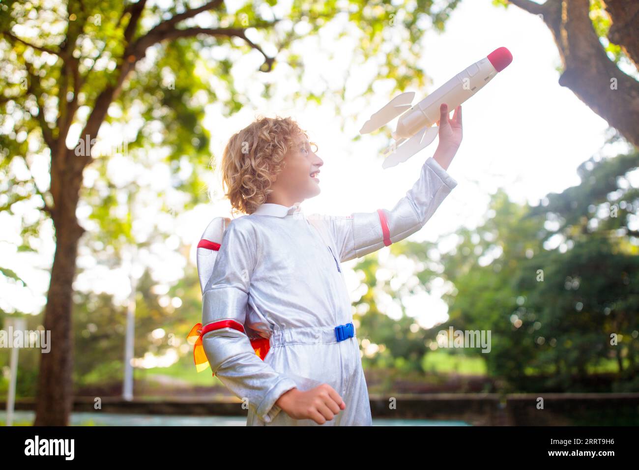 Little boy playing with spaceship. Astronaut costume for Halloween ...