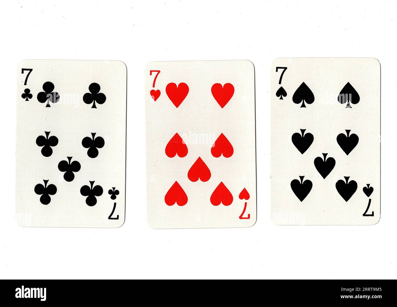 Vintage playing cards showing three sevens on a white background Stock ...