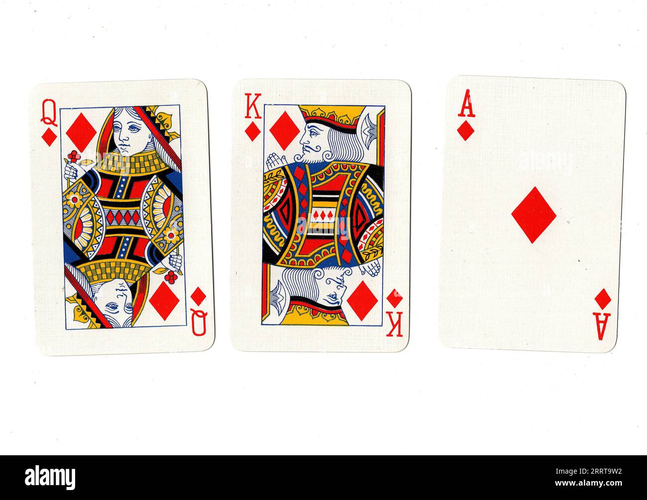 Vintage playing cards showing a queen, king and ace of diamonds on a ...