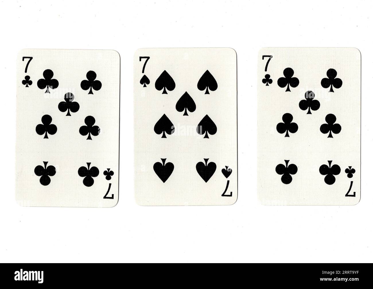 Vintage playing cards showing three sevens on a white background Stock ...