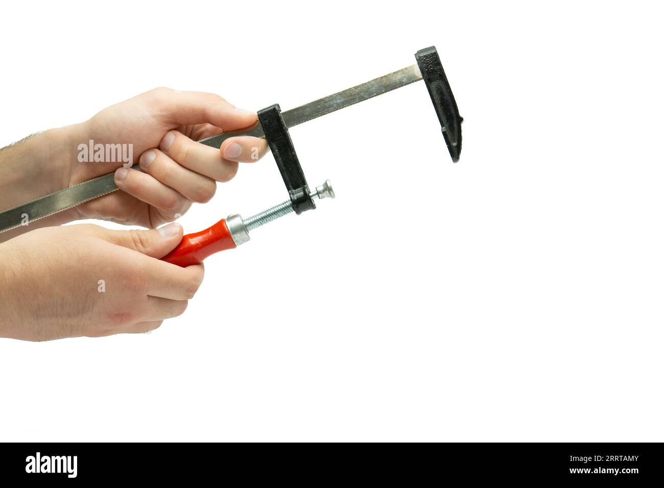 Male hand holding metal screw clamp isolated on white background Stock ...