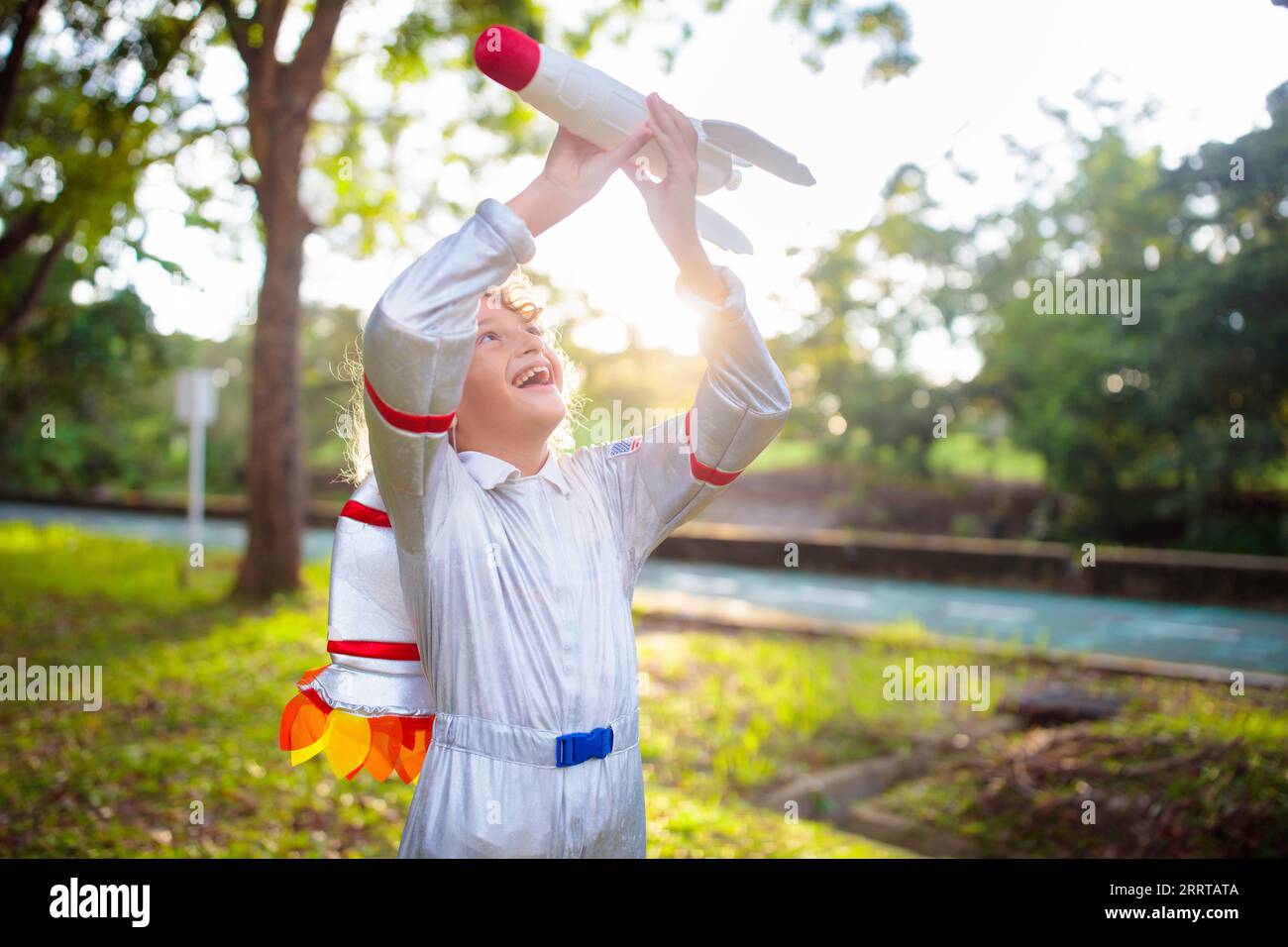 Little boy playing with spaceship. Astronaut costume for Halloween ...
