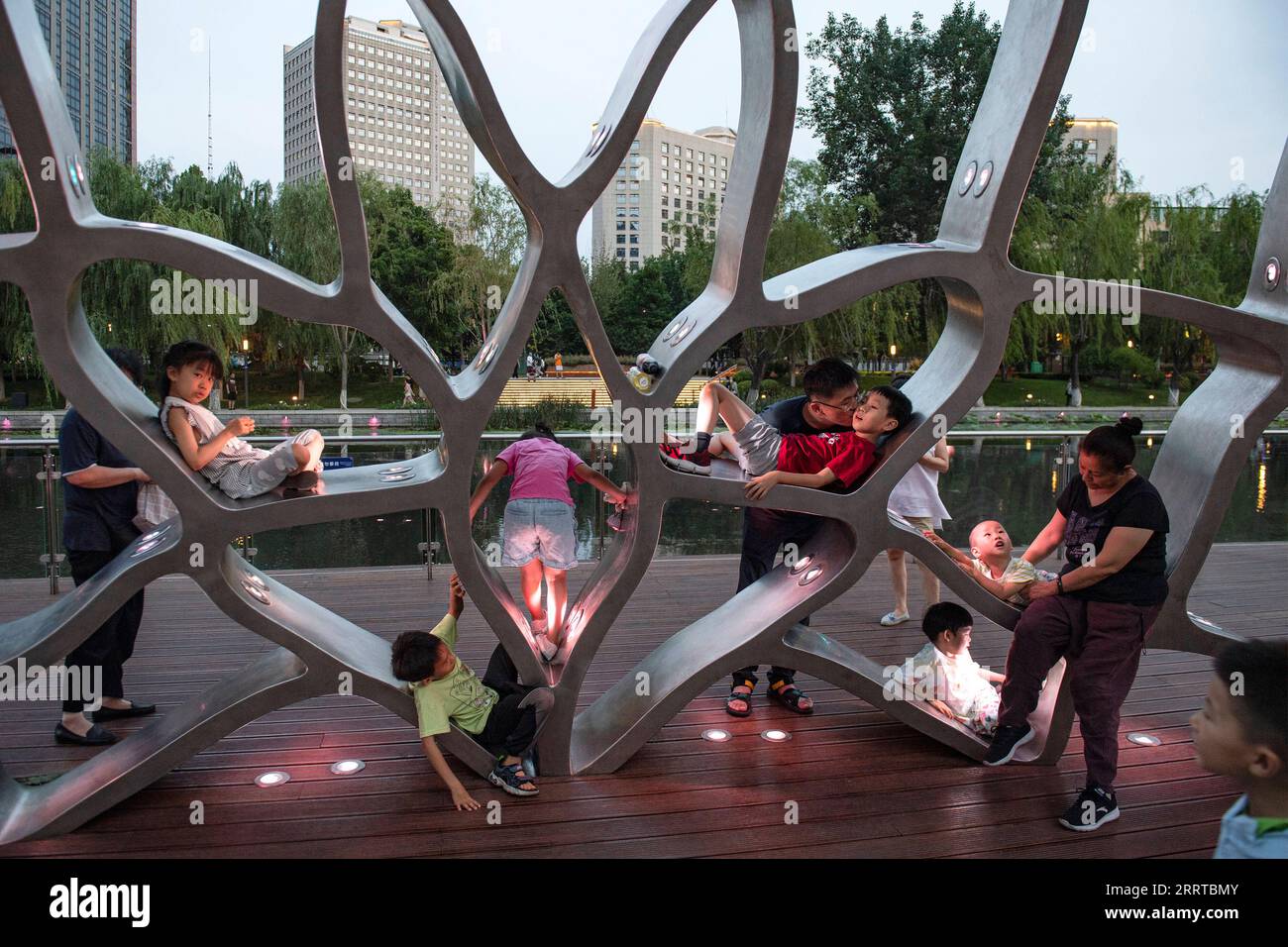 230713 -- BEIJING, July 13, 2023 -- People have fun by the Liangma ...