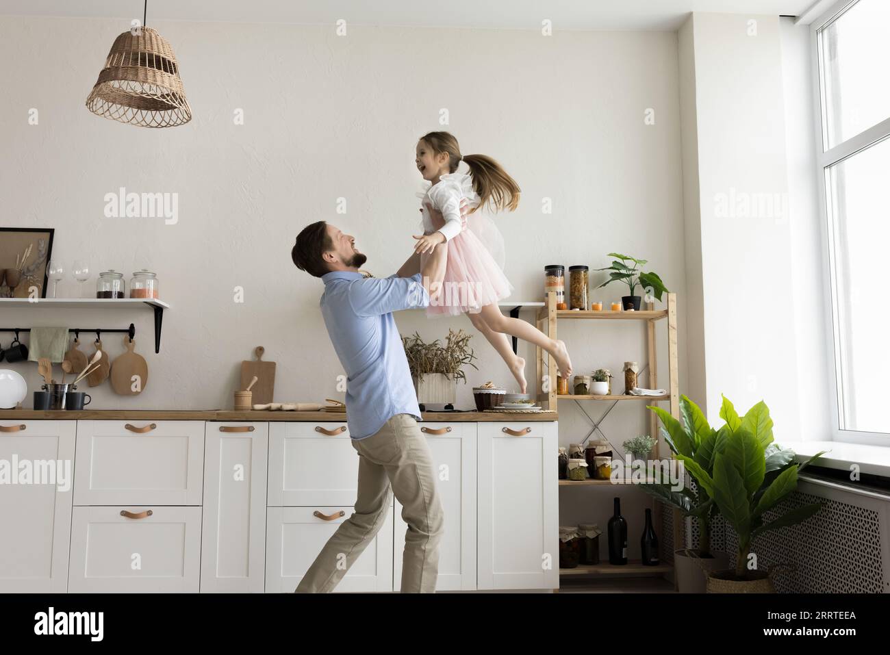 Happy strong dad playing active games with cheerful excited girl Stock ...