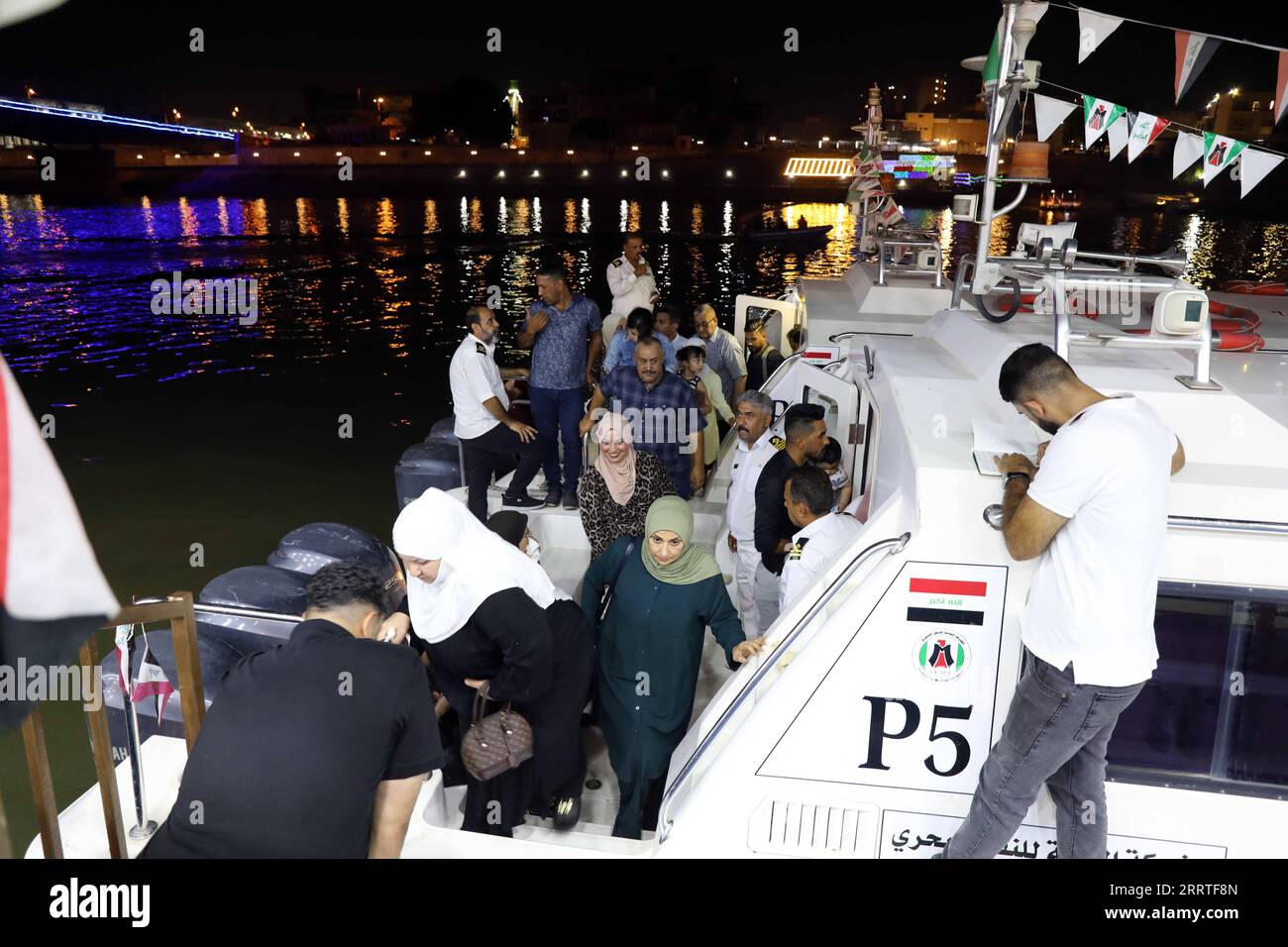 230722 -- BAGHDAD, July 22, 2023 -- People take a river taxi in Baghdad ...