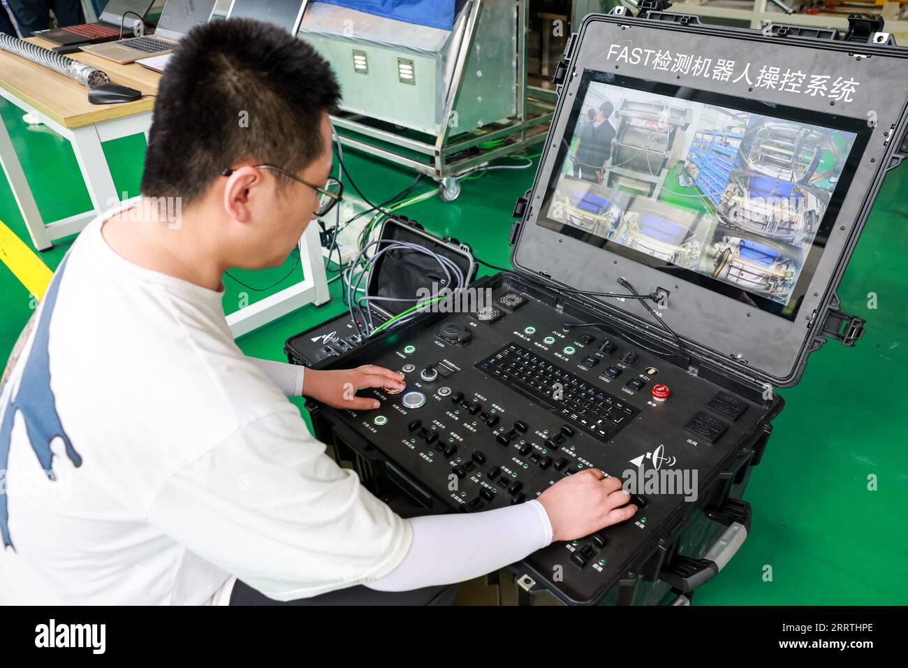 230727 -- PINGTANG, July 27, 2023 -- A staff member adjusts a ...