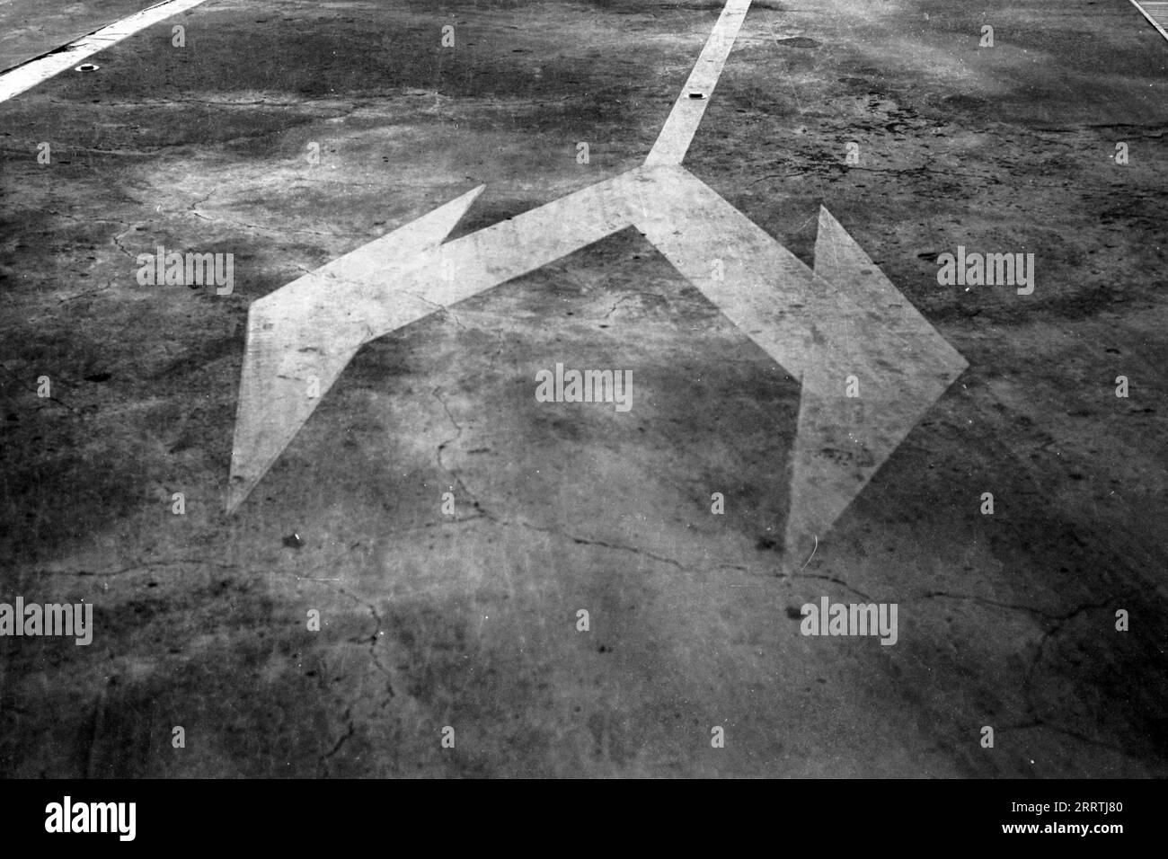 Arrow road marking on concrete surface of a harbour street, shot on ...