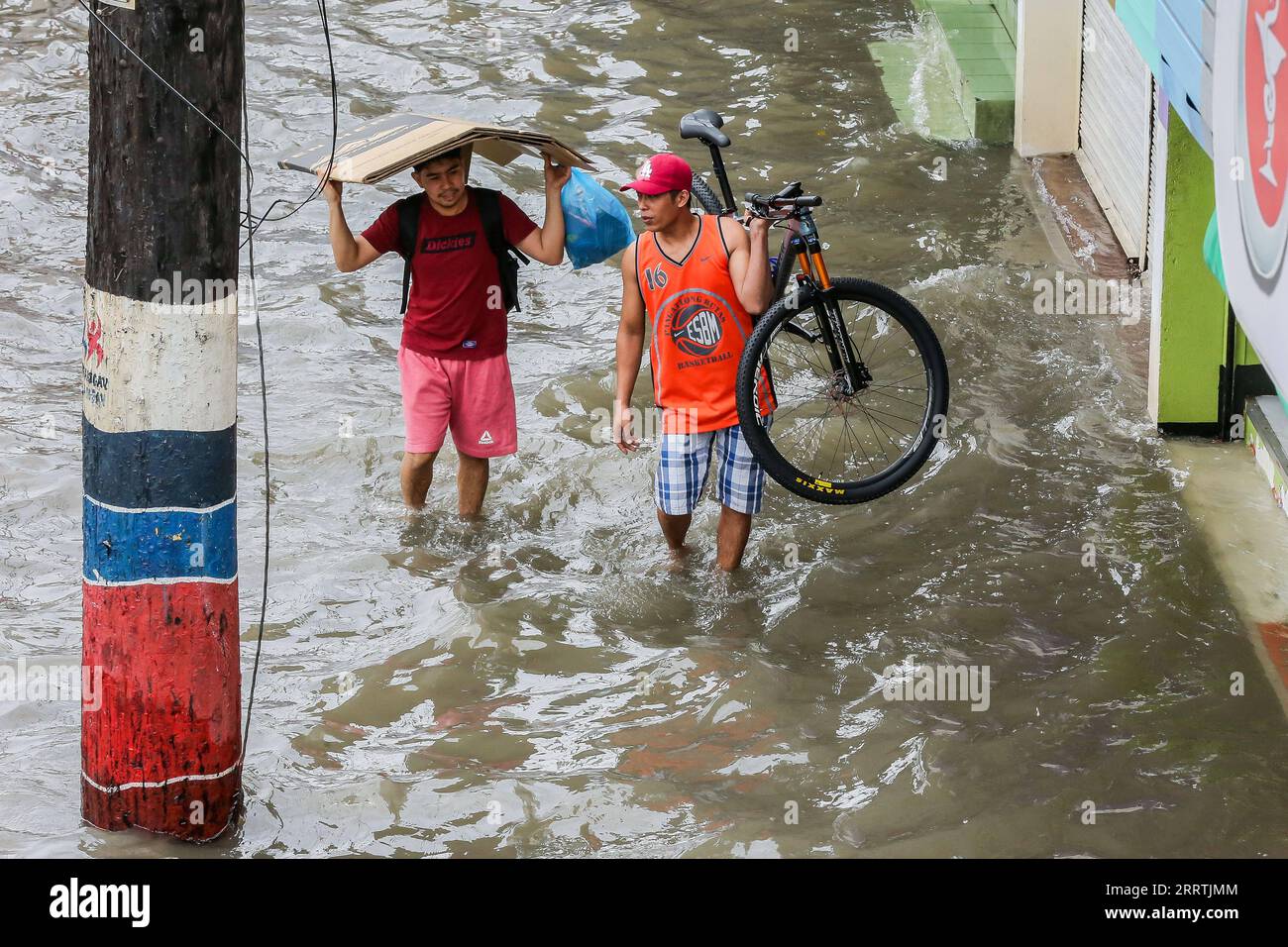 230728 -- VALENZUELA CITY, July 28, 2023 -- People wade through ...