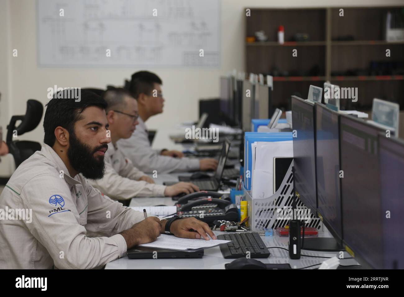 230728 -- LAHORE, July 28, 2023 -- Zubair Tufail front works in the control room at a converter ...