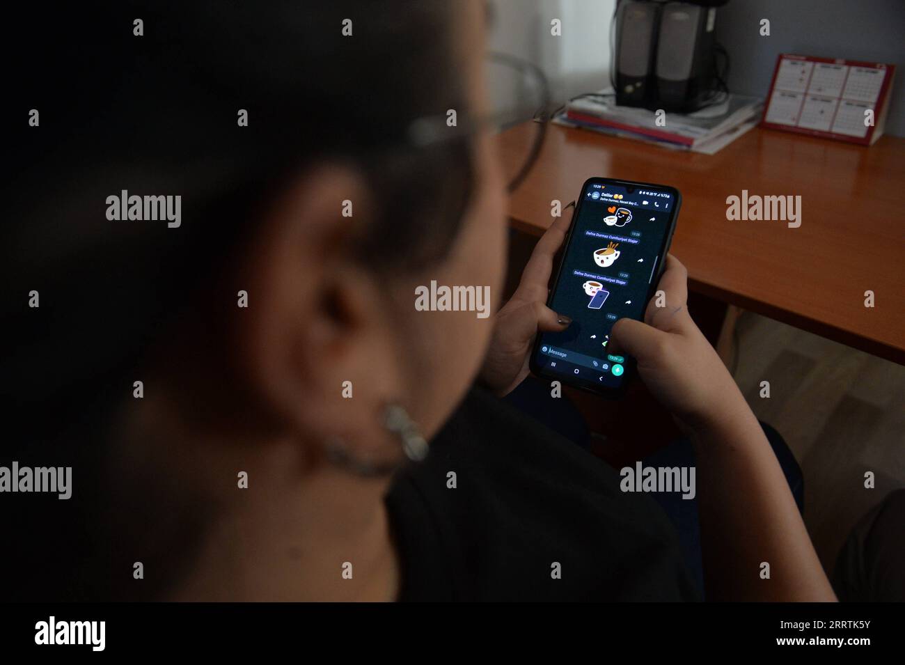 230728 -- ANKARA, July 28, 2023 -- A local resident sends texts with ...