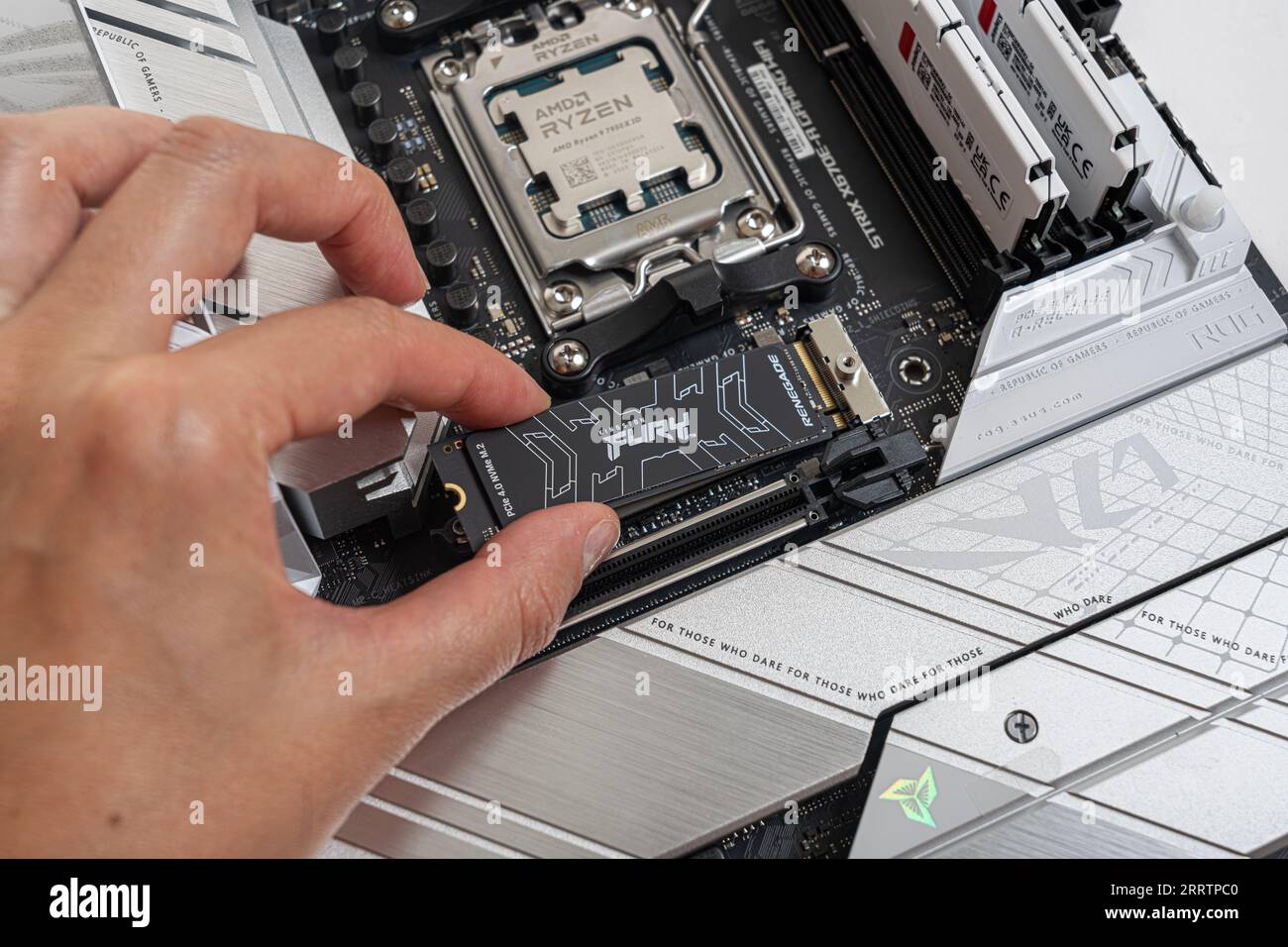 Installing an M2 SSD Kingston FURY Renegade on a PC motherboard during ...