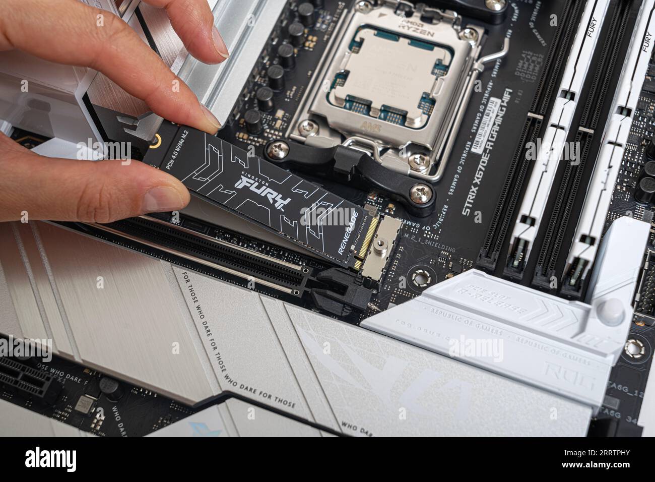 Installing an M2 SSD Kingston FURY Renegade on a PC motherboard during ...