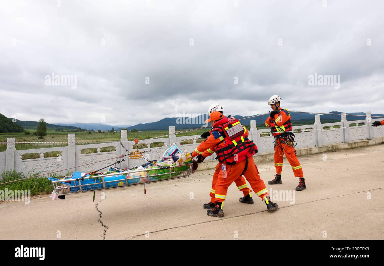 230806 -- JILIN, Aug. 6, 2023 -- Rescuers transfer a trapped villager ...
