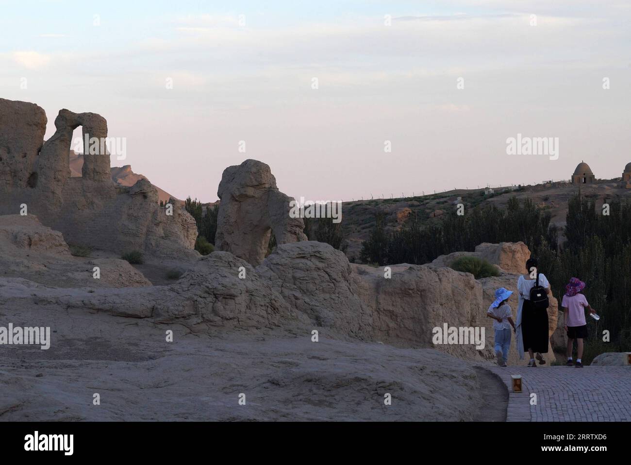 230812 -- TURPAN , Aug. 12, 2023 -- People visit the Jiaohe ancient ...