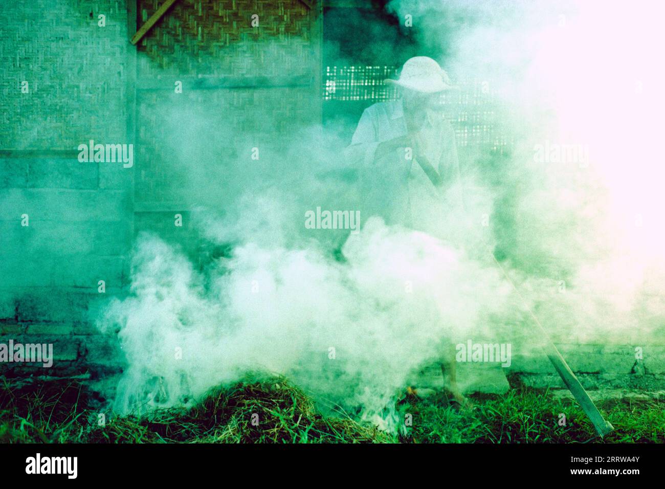Local Balinese farmer burning trash outside in the field causing air ...