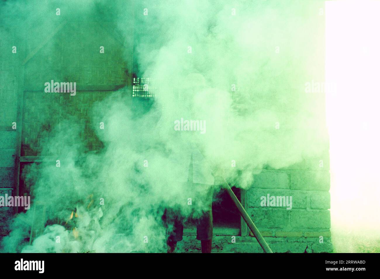 Local Balinese farmer burning trash outside in the field causing air ...