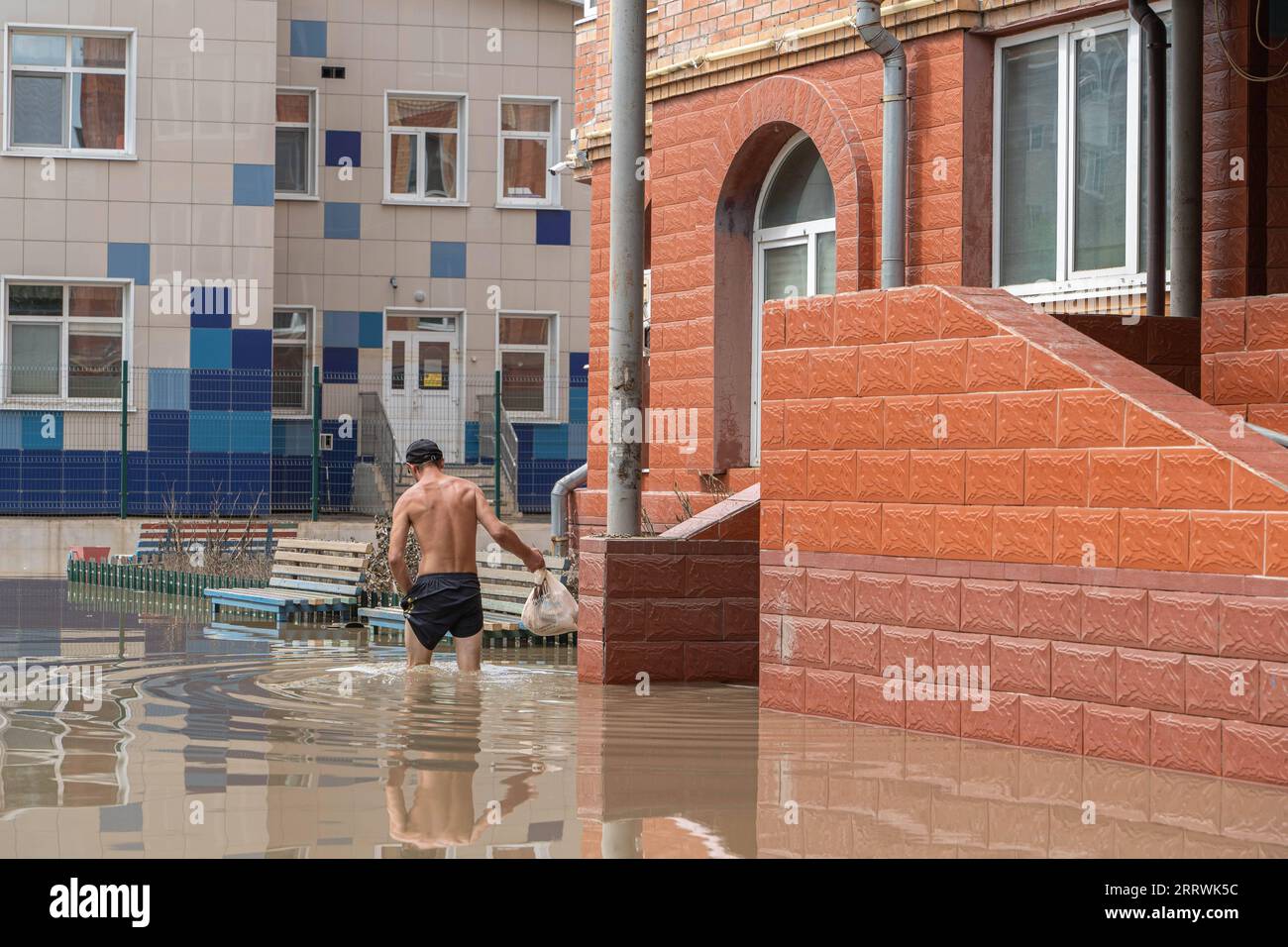 230815 -- VLADIVOSTOK, Aug. 15, 2023 -- A man wades in flood water in ...