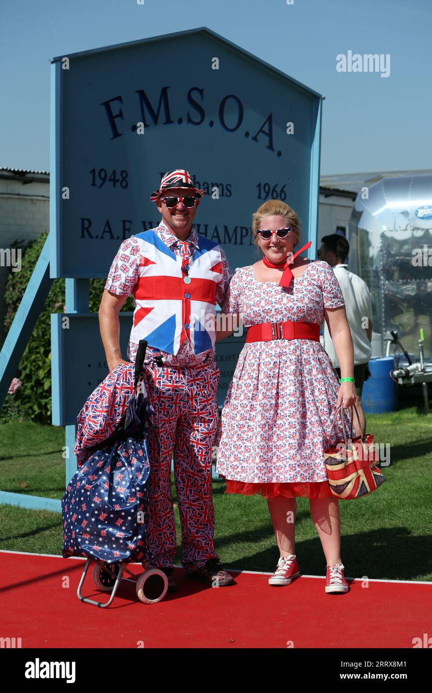 Visitors pose in vintage clothing at the Goodwood Revival at the ...