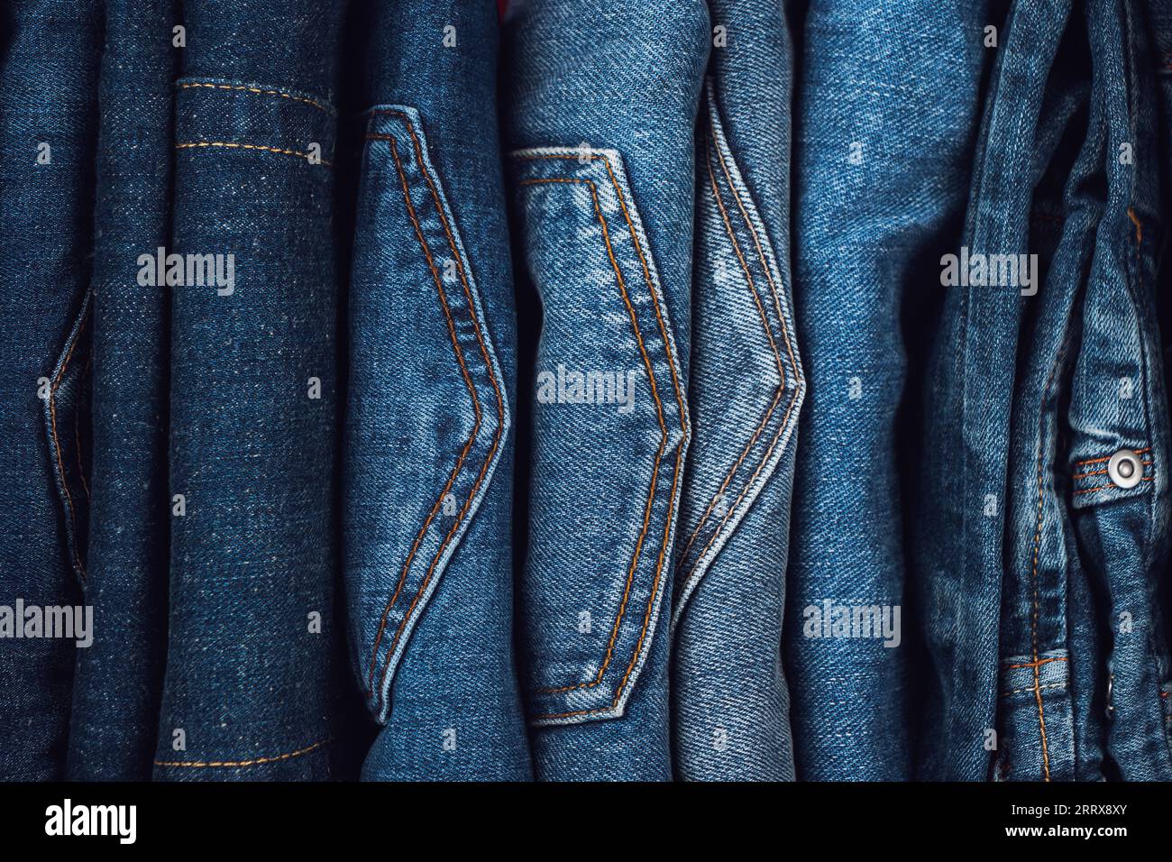 Denim background. Pile of blue jeans. Vertical storage of clothing. Top ...